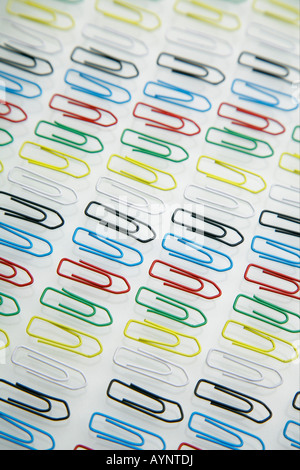 Vertical shot of multicolored paper clips on a piece of paper Stock ...
