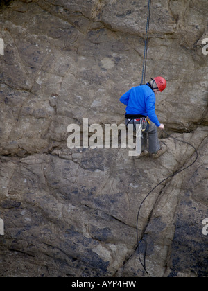 Man abseiling down a rock face in Cathedral quarry, Little Langdale in ...