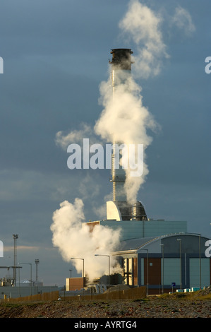Steam and smoke coming from tall chimneys at coal burning power plant ...