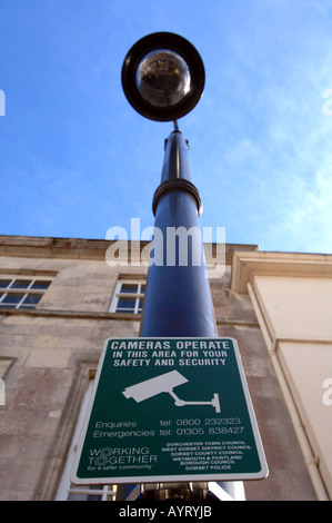 Blue surveillance camera security sign on stone wall in residential ...