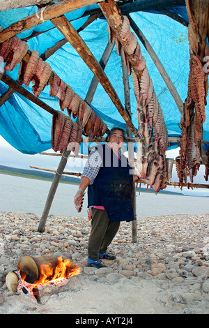 Elder Inuit woman with dried fish in smoke tent Stock Photo - Alamy