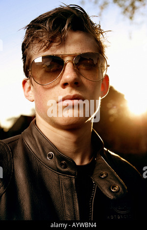 handsome rocker in sunglasses posing playing electric guitar isolated ...