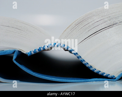 A hard cover printed book opened Pages fanned out with graduated ...