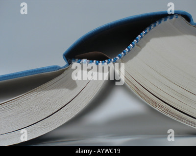 A hard cover printed book opened Pages fanned out with graduated ...