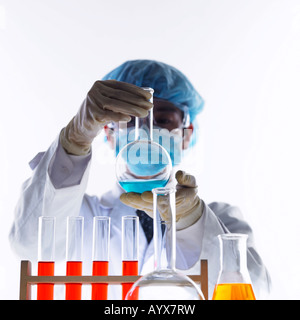 man doing experiment with various fluid Stock Photo - Alamy