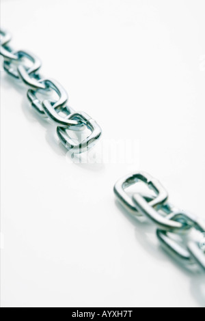 A silver link chain, broken with missing links on a silver background ...