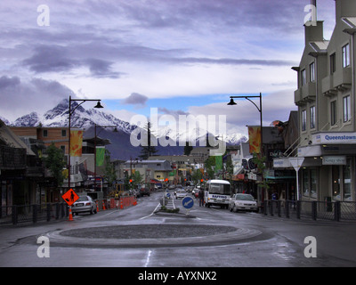 Queenstown main street with high snow capped mountains in background ...