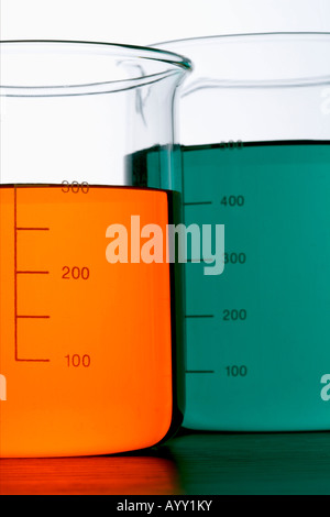 Close up of a glass beakers with yellow liquid standing in a laboratory ...