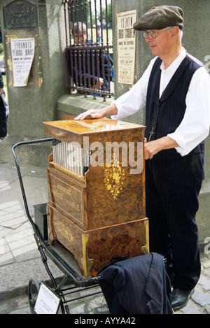 An organ grinder playing his street organ at the open-air town museum ...