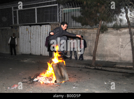 Iranian people jumping over bonfires during the festival of fire prior ...