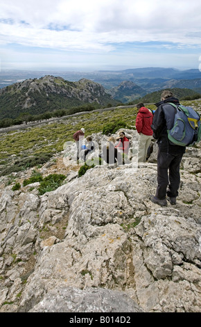 Group of people resting on the mountain top, by E R Ober Stock Photo ...