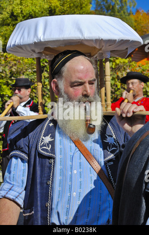 A Swiss farmer in traditional dress, with his prizewinning Simmental ...
