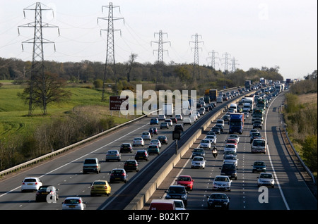 Busy road and electricity pylons Stock Photo - Alamy