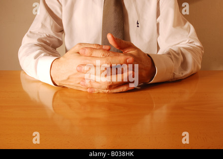 Hand gestures: explaining with interlaced fingers Stock Photo - Alamy