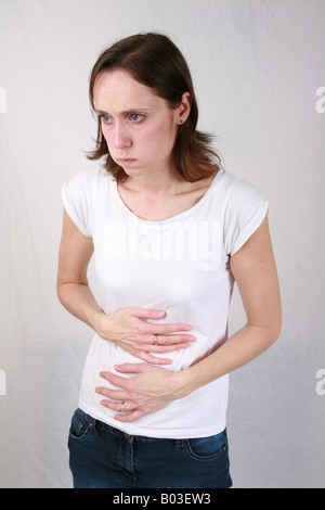 Young woman vomiting while binge eating of candies. A lot of candy ...
