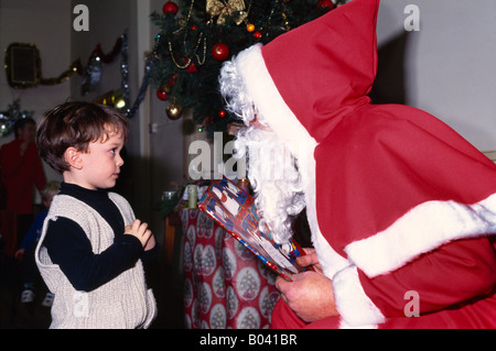 Father Christmas Giving Present At Kindergarten Stock Photo - Alamy
