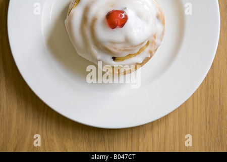 Belgian pastry bun icing and cherry Stock Photo - Alamy