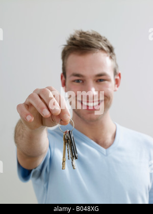 Man holding keys Stock Photo - Alamy