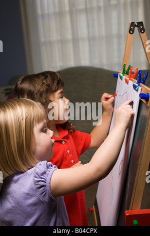 Two girls drawing a picture Stock Photo - Alamy