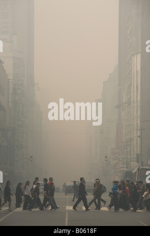 People cross a street in a downtown area of Sapporo in Hokkaido ...