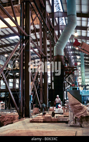 Primary aluminum reduction facility pot line with worker using radio to ...