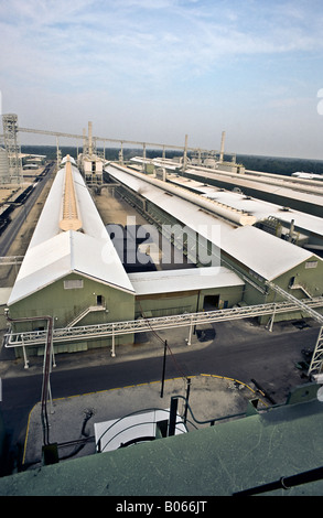 Primary aluminum reduction facility pot line with worker using radio to ...