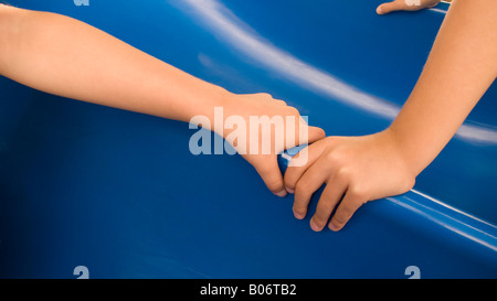four children hold up their hands which are covered in paint from ...