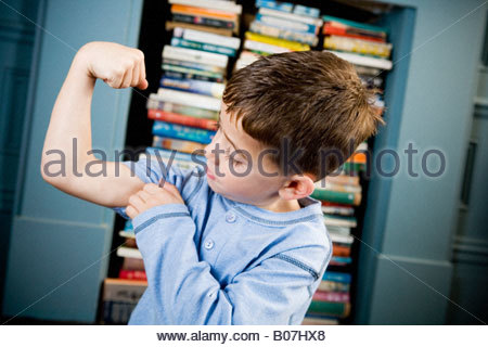 A YOUNG BOY FLEXING HIS MUSCLES Stock Photo: 31065453 - Alamy