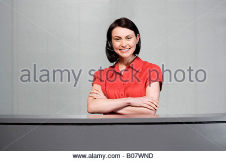 Happy smiling female receptionist in hotel. Beautiful concierge in ...