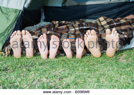 Family s feet sticking out of tent on camping trip Stock Photo: 1260832 ...