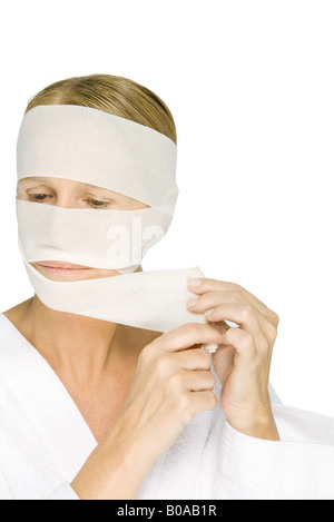Woman taking off bandages Stock Photo - Alamy