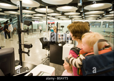 Family having their photo taken at security passport control heathrow ...