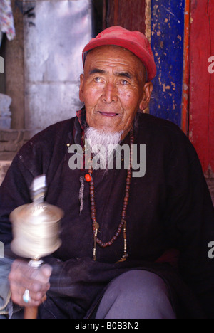 Indian old man with the prayer wheel Stock Photo - Alamy
