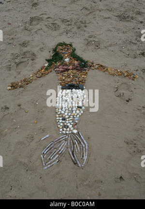 Mermaid made of sand and shells on the beach Stock Photo - Alamy