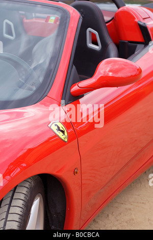 Logo and side of a red Ferrari sports car Stock Photo - Alamy