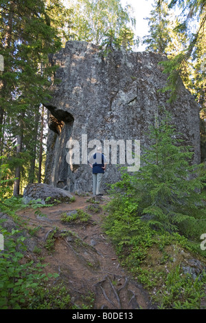 Big stone block standing alone in water at sandy beach. Aerial view of ...
