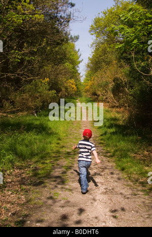 Young boy exploring the British countryside at Loamhole Waterfall in ...