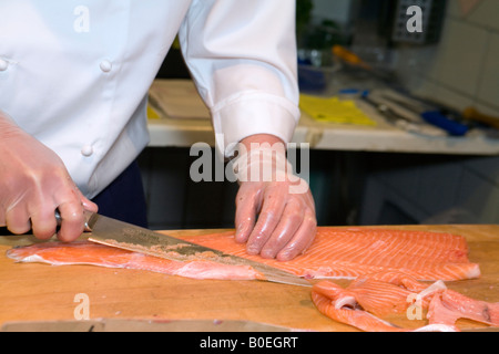 A chef cuts and trims salmon fillets Stock Photo - Alamy