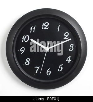 black clock telling time on black background Stock Photo - Alamy