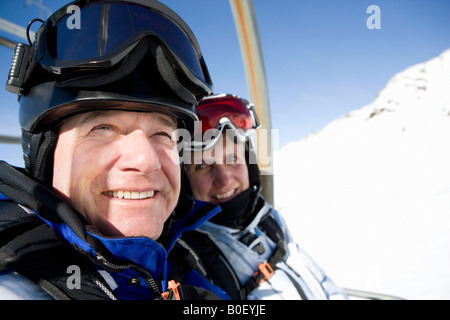 Couple sitting on chair lift Stock Photo - Alamy