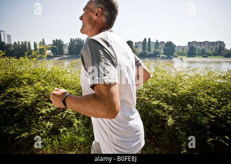 Man jogging in the park on sunny autumn morning Stock Photo - Alamy