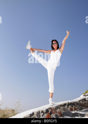 Woman standing on one leg at Elk Lake against clear sky Stock Photo - Alamy