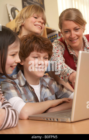 Boy typing on laptop and laughing isolated on white Stock Photo - Alamy