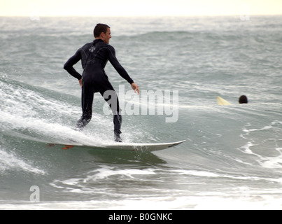 Surfer coming down wave Stock Photo - Alamy