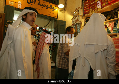 Qatari boys in traditional attire on the street of Doha, Qatar Stock ...