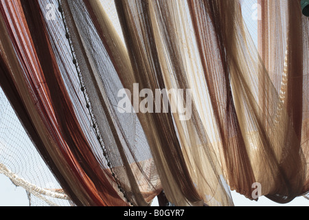 Old fishing nets draped over a beam to provide shade Stock Photo - Alamy