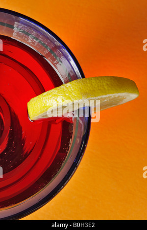 red cocktail with lemon slice Stock Photo - Alamy