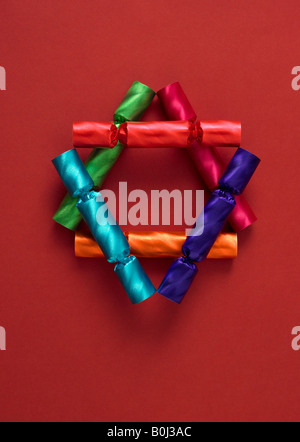 Christmas crackers on a red background Stock Photo - Alamy