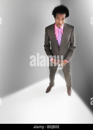 Man standing in room corner facing the wall. Blue toned image Stock ...