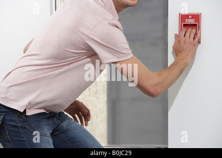 Man starting fire alarm, indoors Stock Photo - Alamy